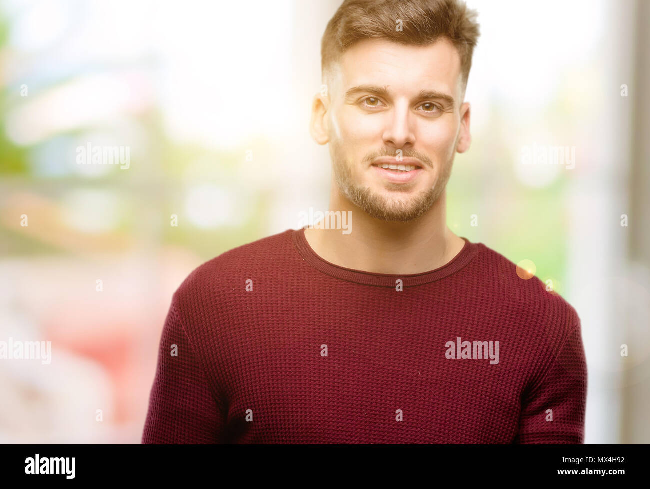 Handsome young man holding something in his empty hand Stock Photo - Alamy
