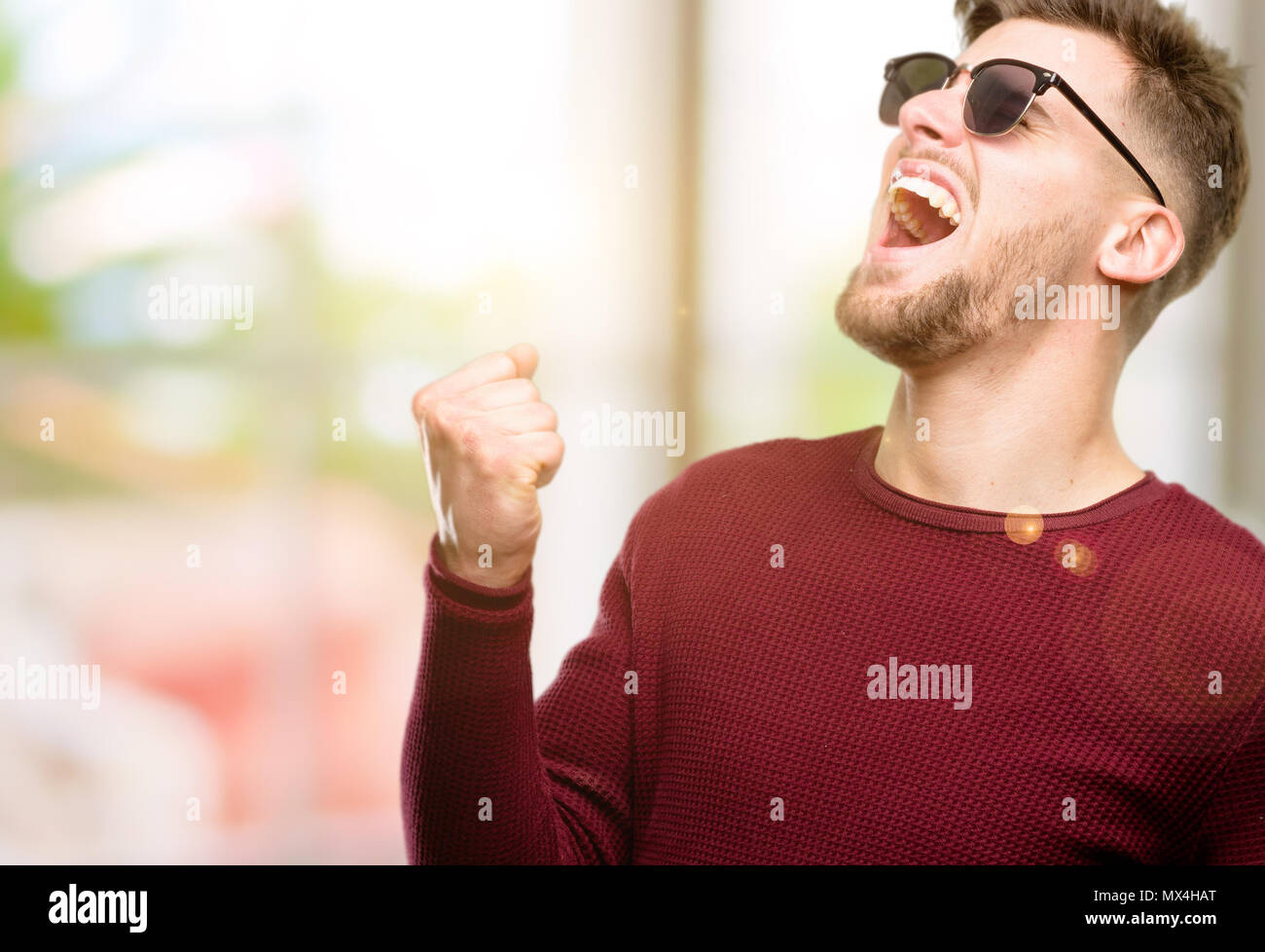 Handsome young man happy and excited celebrating victory expressing big ...