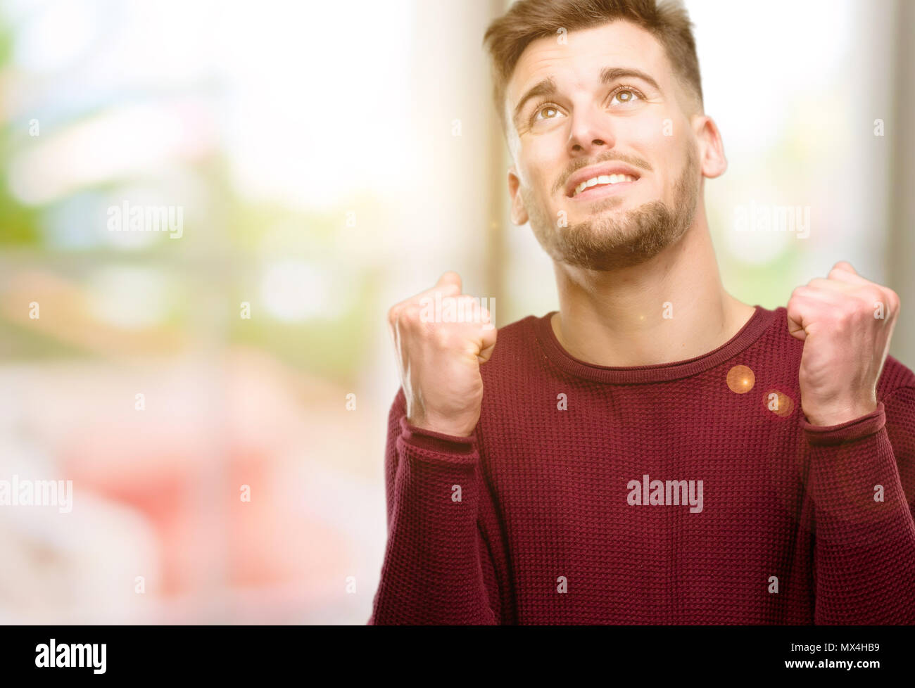 Handsome young man happy and excited celebrating victory expressing big ...