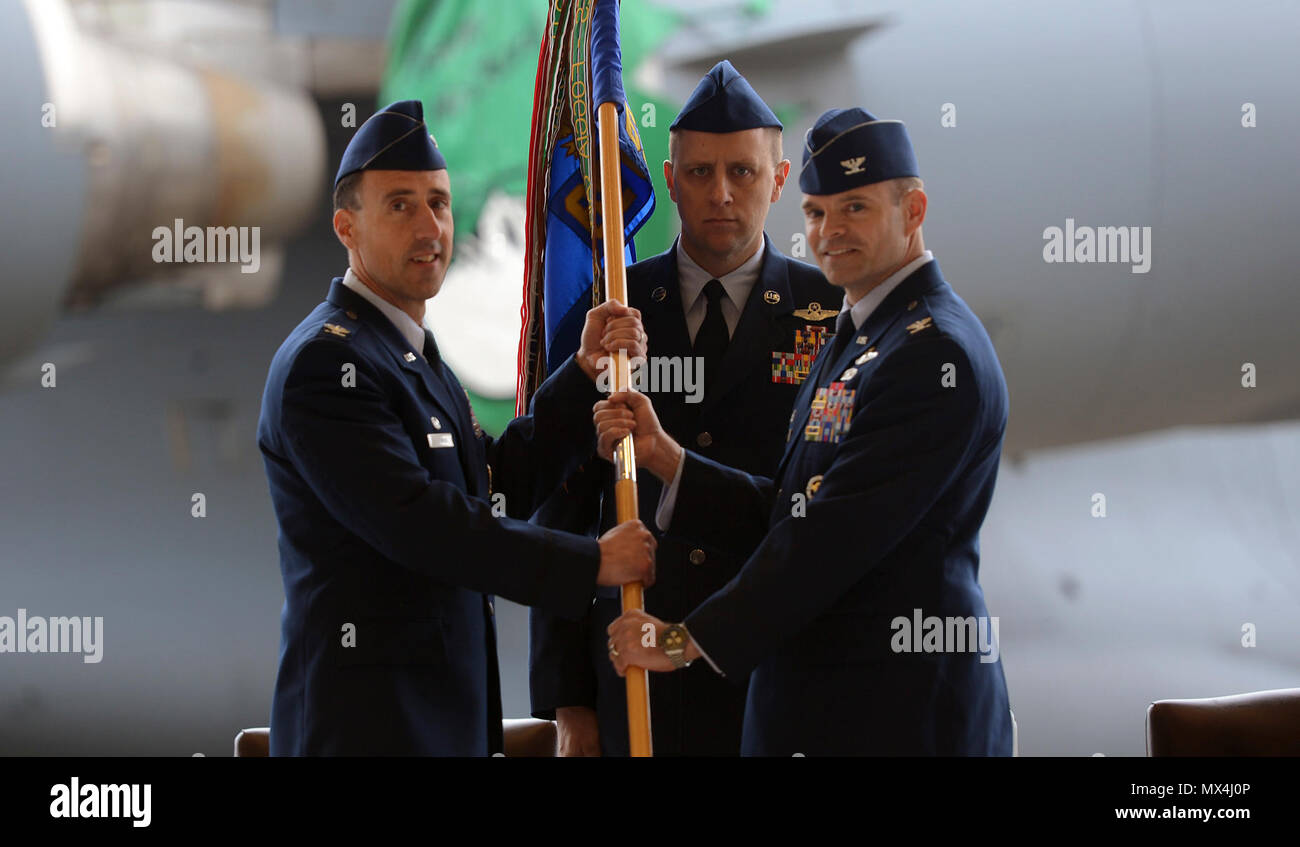 Col. Leonard Kosinski (left), passes a guidon to Col. Mark Fuhrmann ...