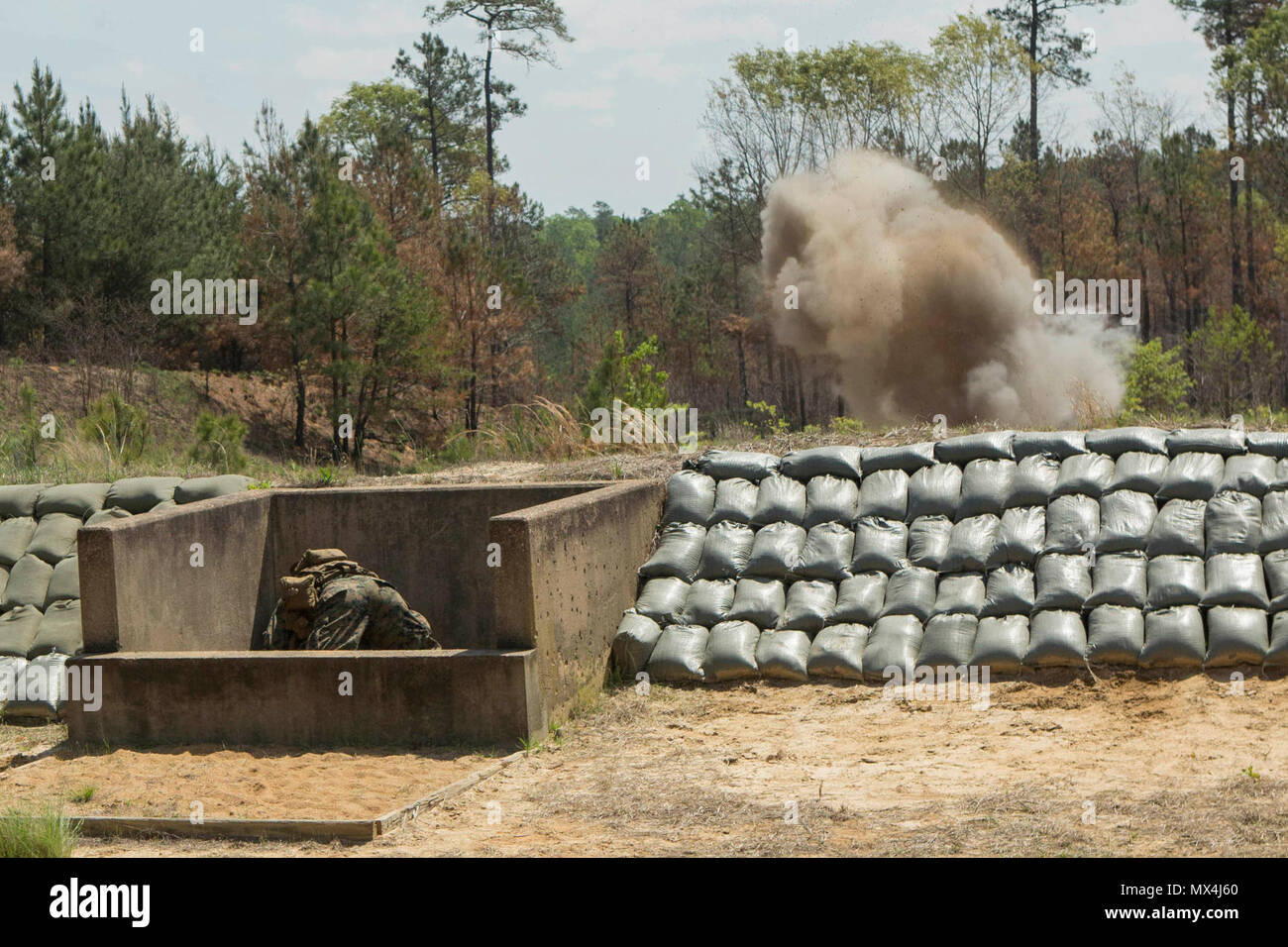 Marines take cover as an M67 fragmentation grenade detonates during a ...