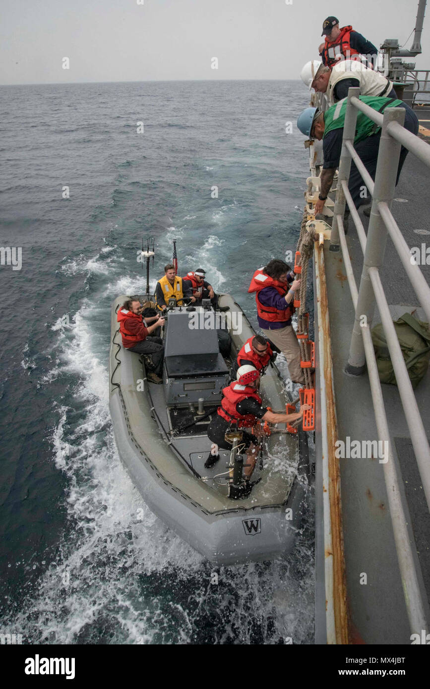 ARABIAN GULF (May 1, 2017) Passengers climb down a rope ladder from the ...