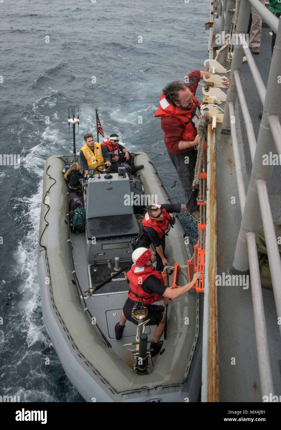 ARABIAN GULF (May 1, 2017) Passengers climb down a rope ladder from the ...