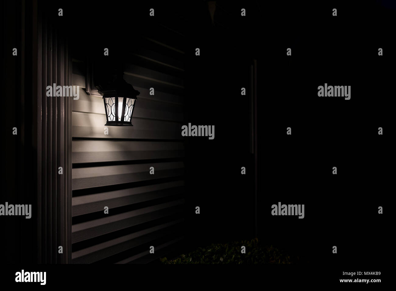 Dark night evening with house exterior lamp lantern, illuminated front ...