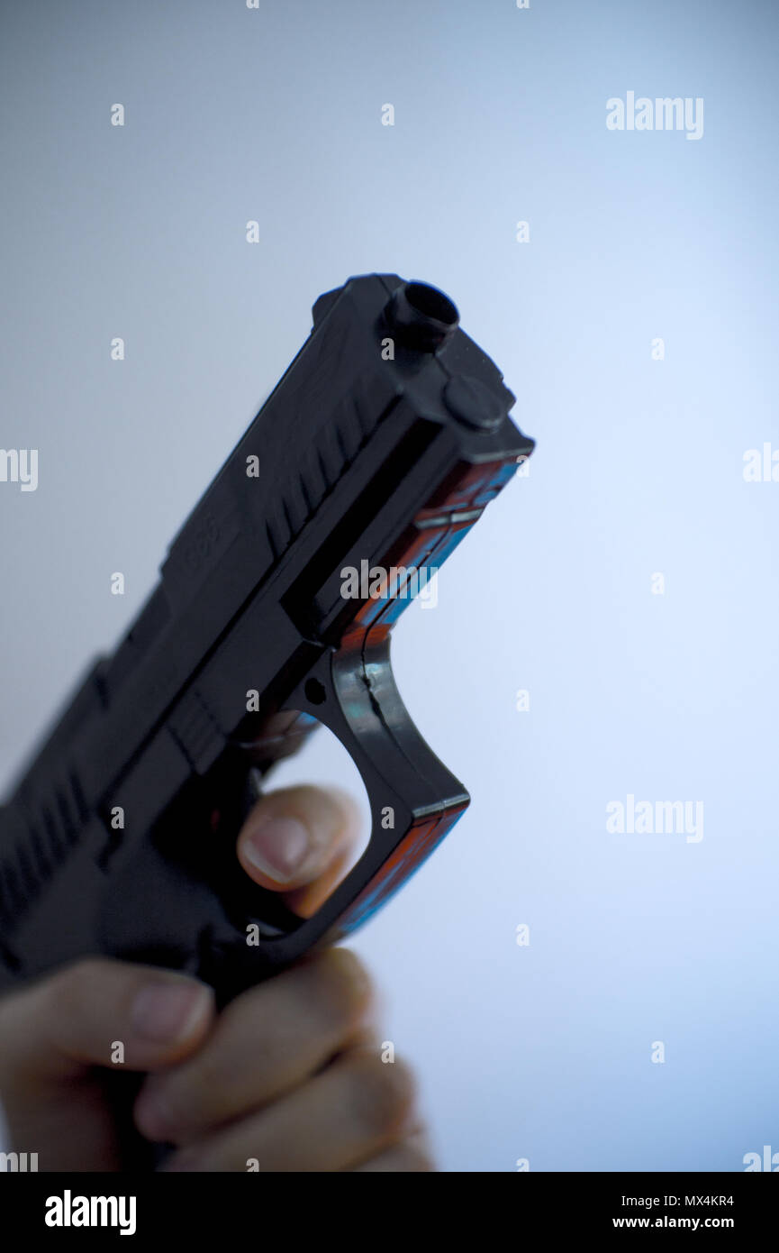 Gun held by a mans hand Stock Photo - Alamy
