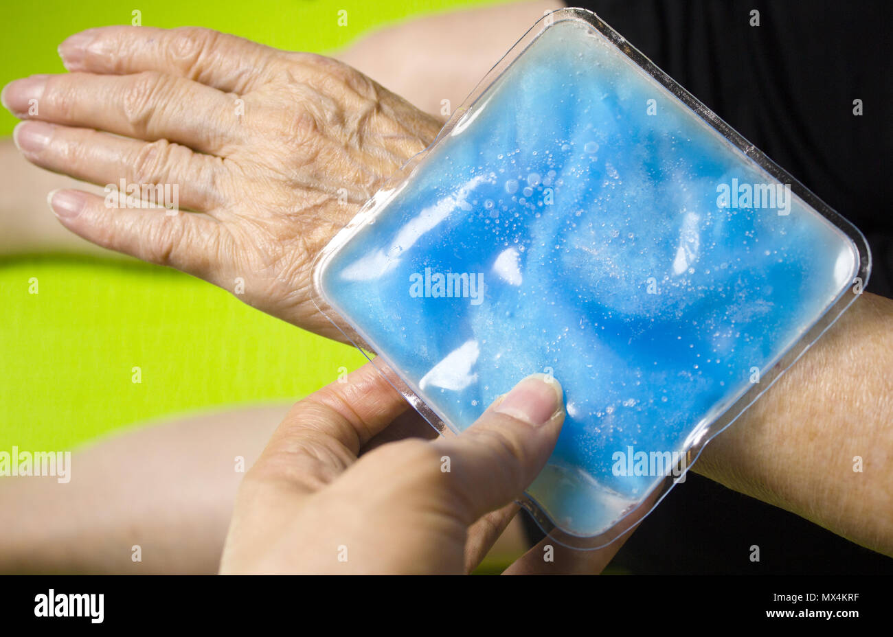 Old woman with ice pack for muscle aches Stock Photo - Alamy