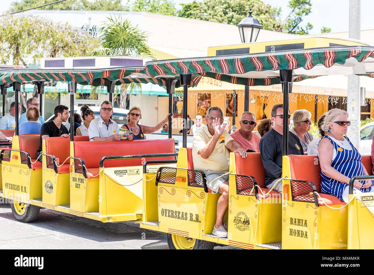 Key West, USA - May 1, 2018: People riding tour bus trolley happy ...