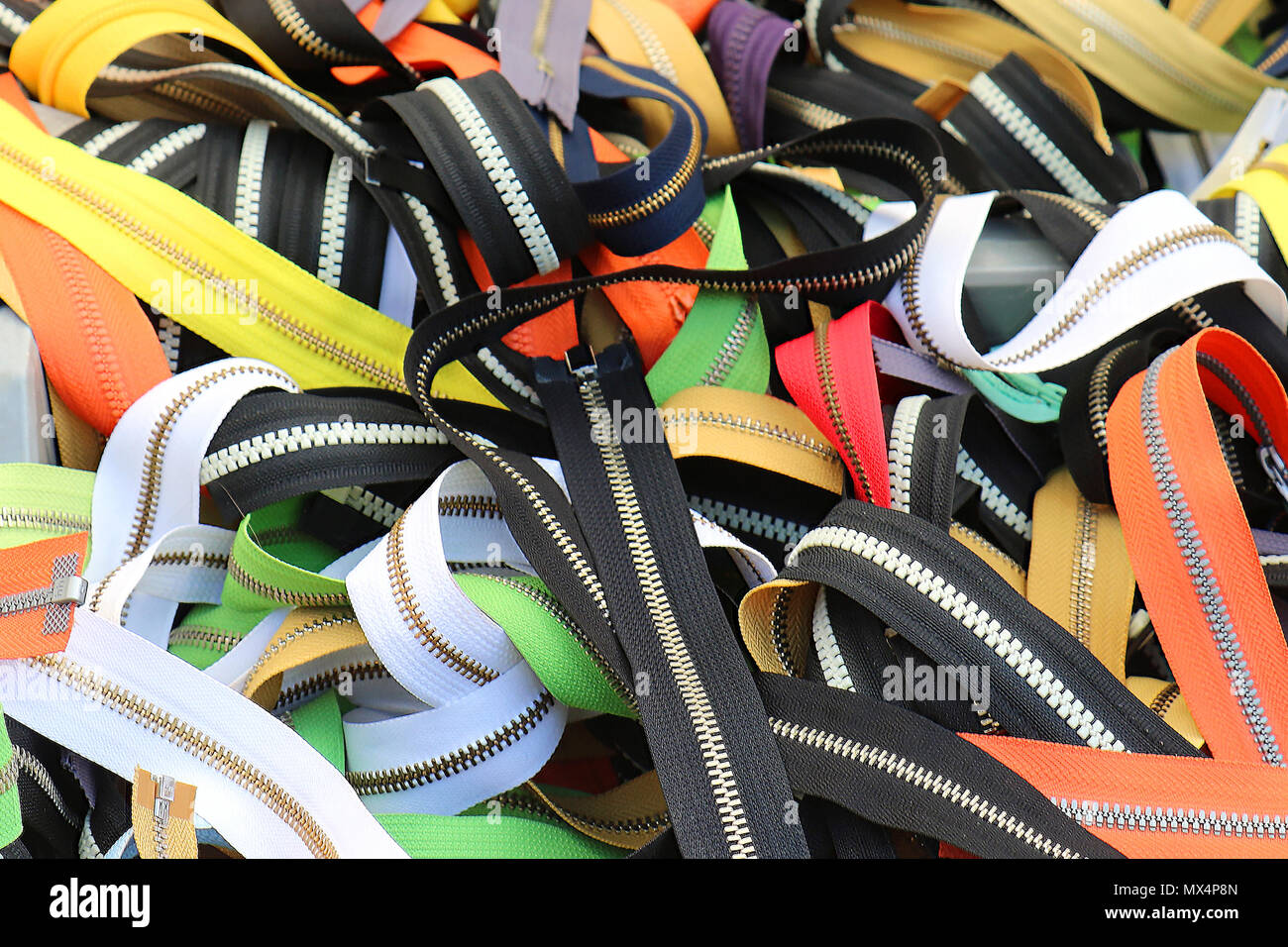 Large pile of colorful zippers used in clothes industry Stock Photo - Alamy