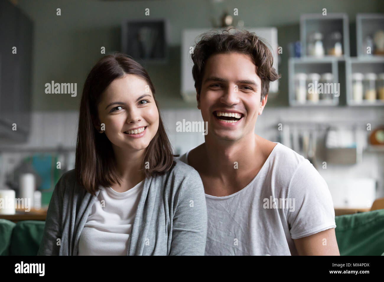 Happy millennial couple looking at camera in kitchen, headshot p Stock ...