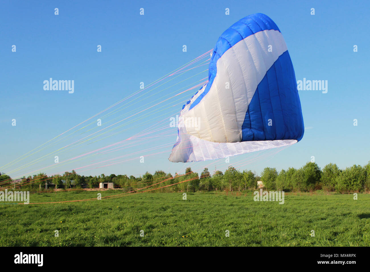 pilot newcomer paraglider is trained on the ground to lift up and hold ...