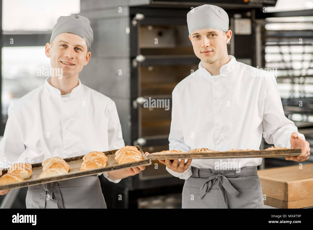 Bakers with buns at the bakery Stock Photo - Alamy
