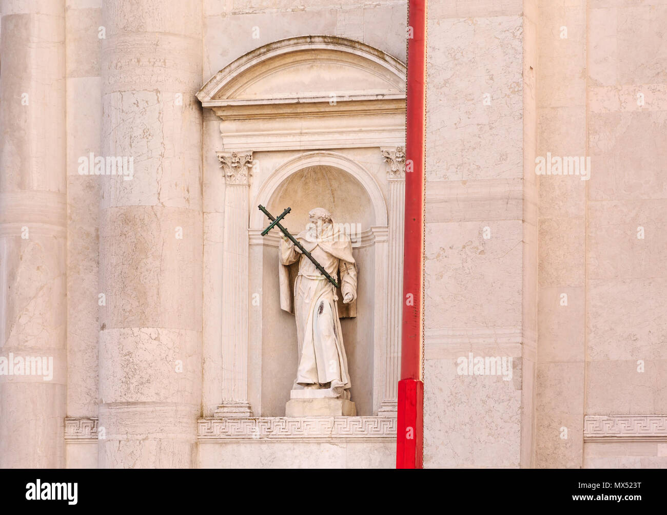 Statue of a Man with Cross on Church in a Niche Stock Photo - Alamy
