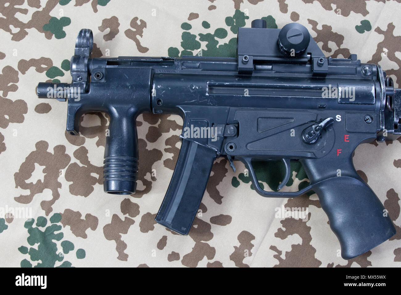 modern submachine gun MP5 on desert camouflaged background Stock Photo ...