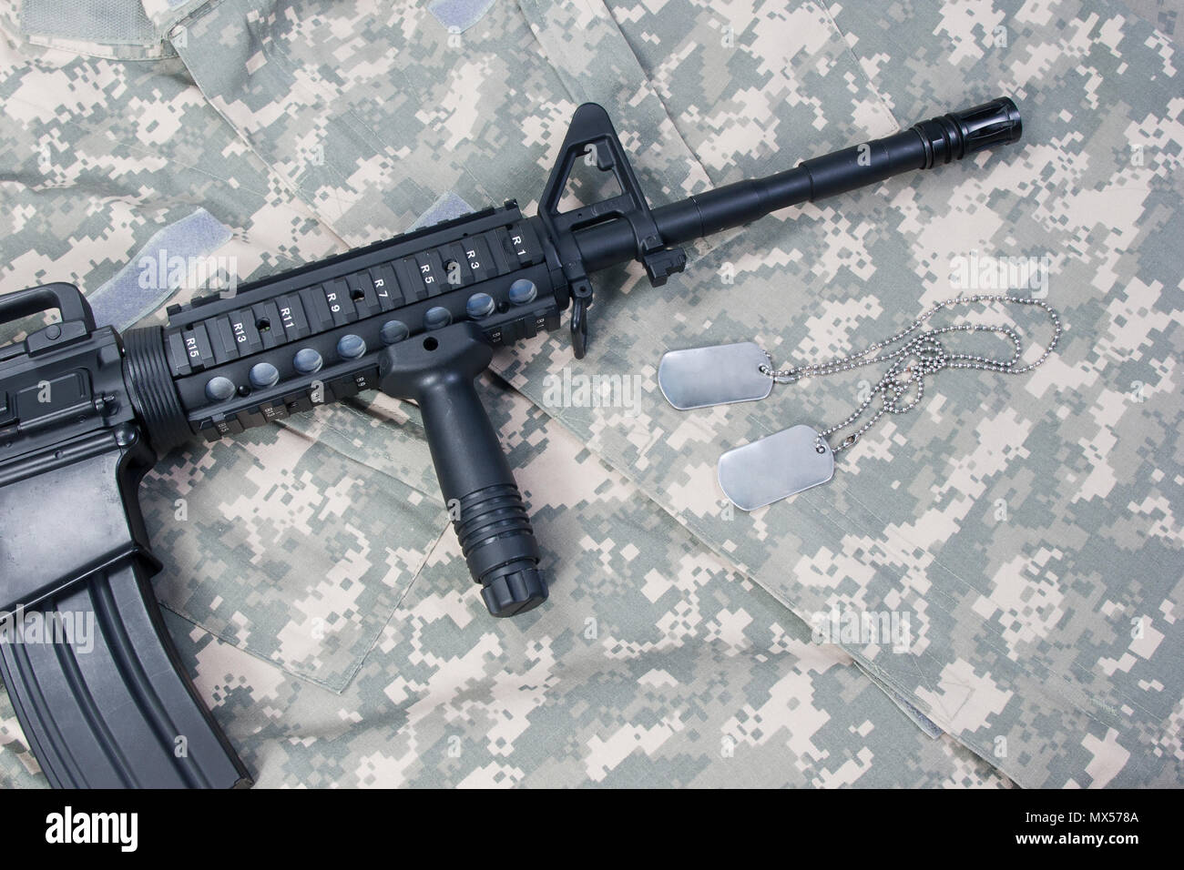 M4 carbine with blank dog tags on camouflage uniform Stock Photo - Alamy