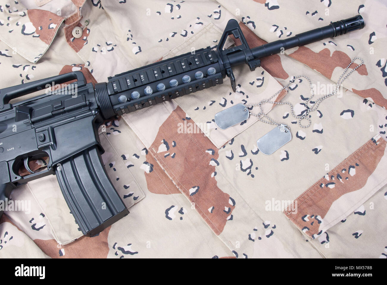 M4 carbine with blank dog tags on desert camouflage uniform Stock Photo ...