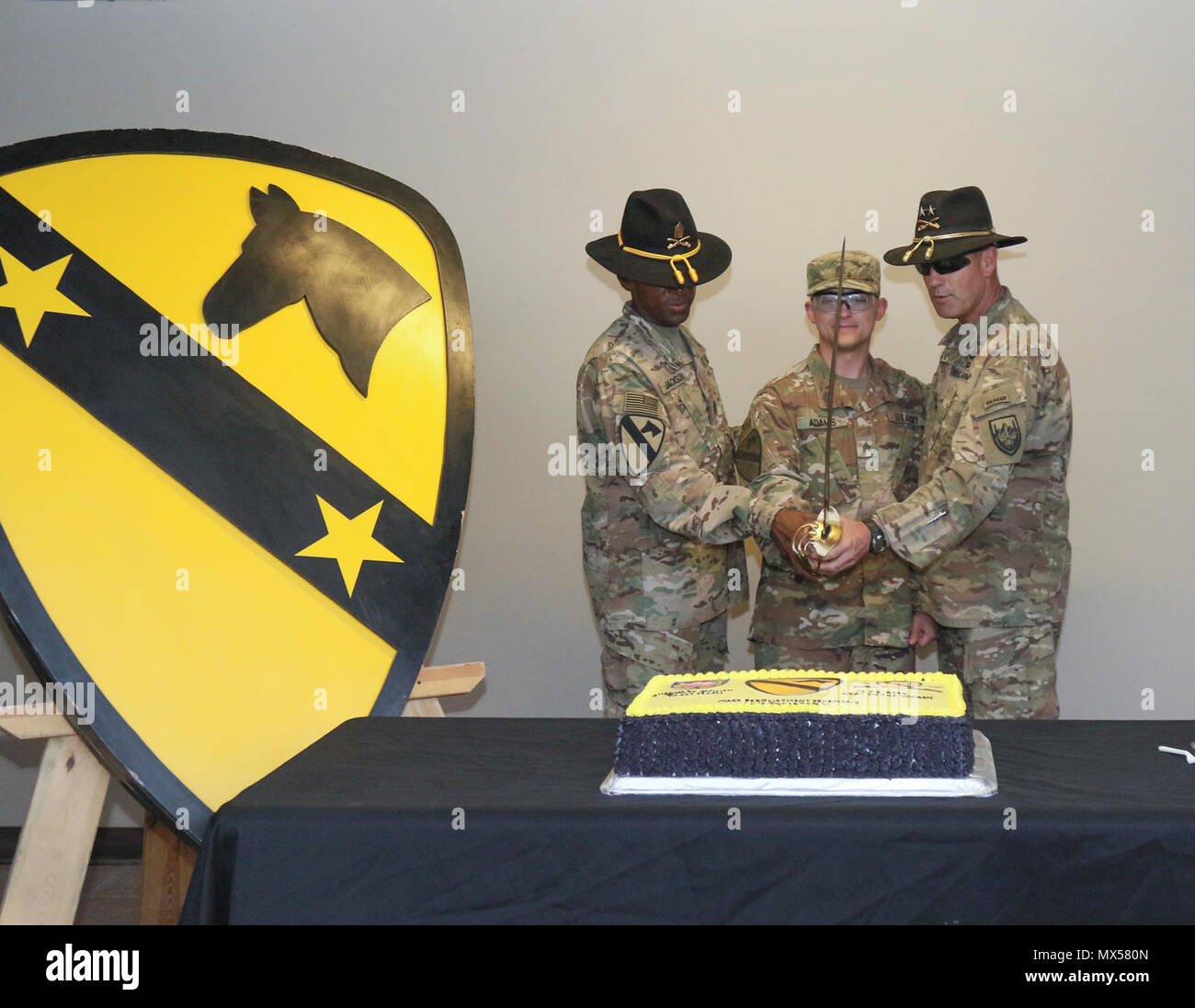 Sgt. Joel Adams, the youngest Soldier to reenlist cuts the cake with ...