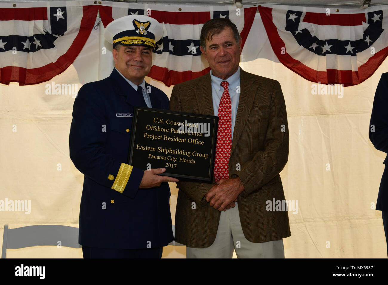 Coast Guard admiral, Michael J. Haycock , accepts a ceremonial plaque ...