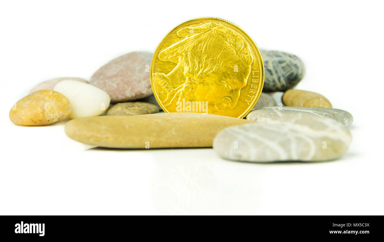 golden buffalo coin with grey pebblestones on white background Stock ...