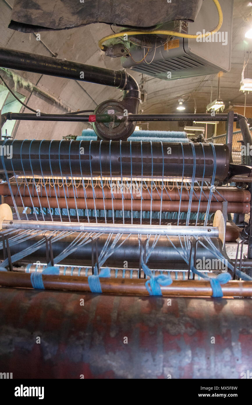 Wool carding; brushing of wool fibres with wire teeth to align the ...