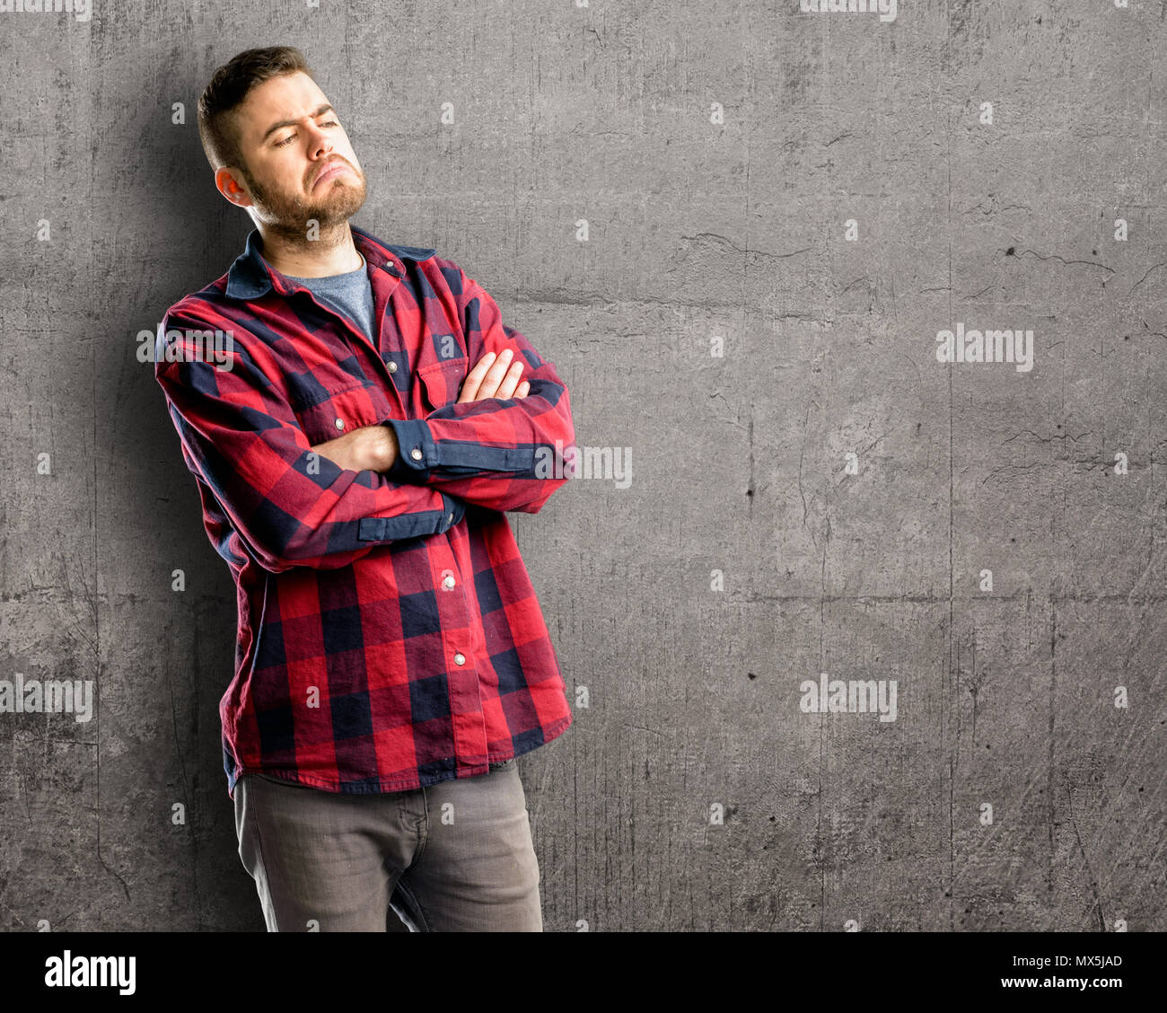 Young handsome man with crossed arms confident and happy with a big ...