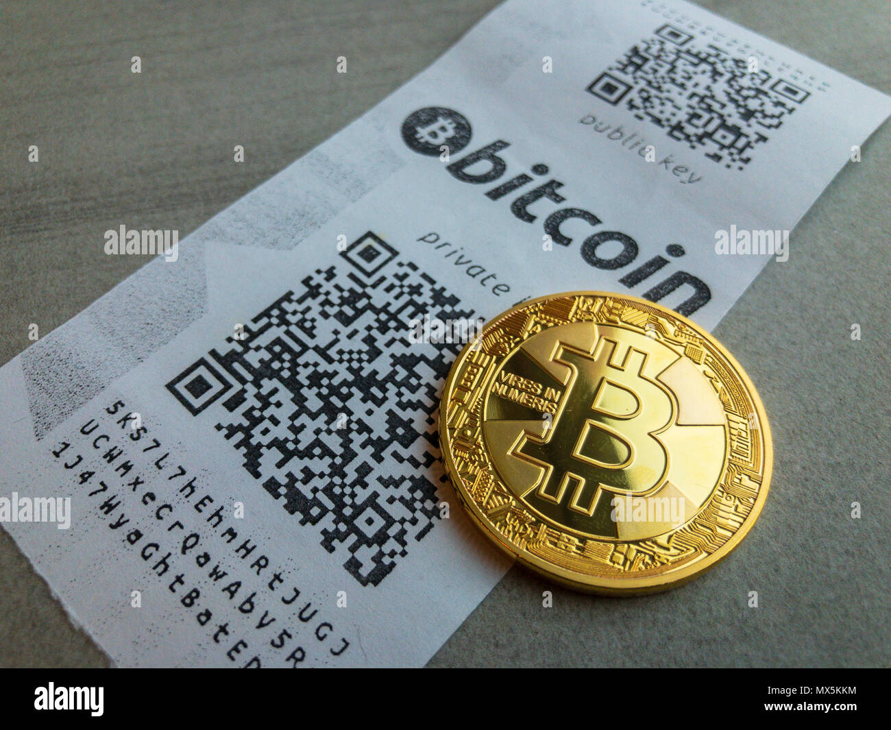 Golden bitcoin coin lying on the receipt Stock Photo - Alamy