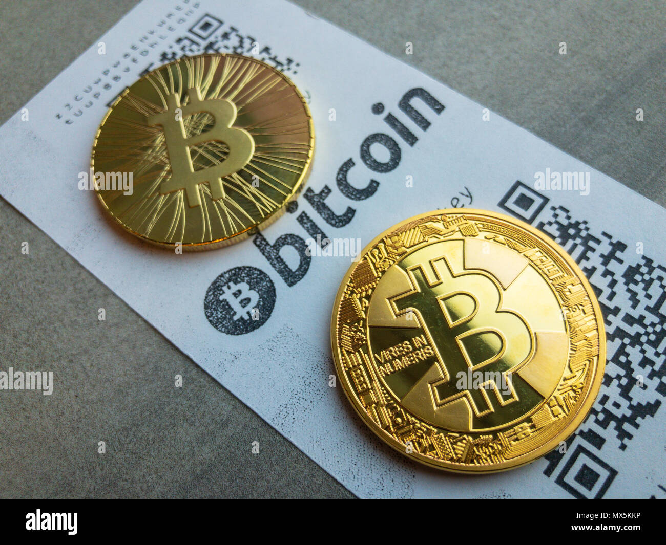 Golden bitcoin coin lying on the receipt Stock Photo - Alamy
