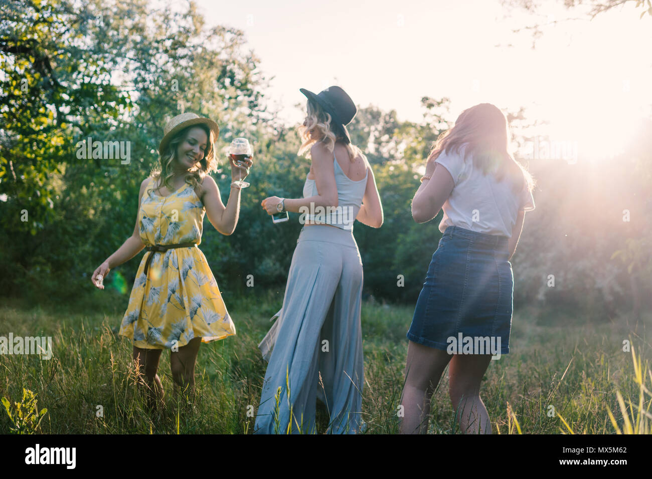 Group of girls friends making picnic outdoor. They have fun Stock Photo ...