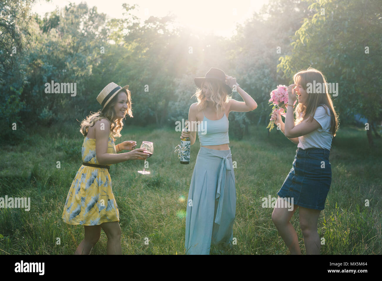 Group of girls friends making picnic outdoor. They have fun Stock Photo ...
