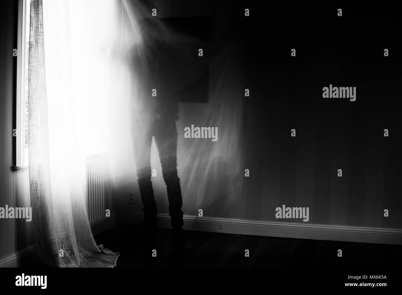 Artistic image with motion blur and grain of person standing in front ...