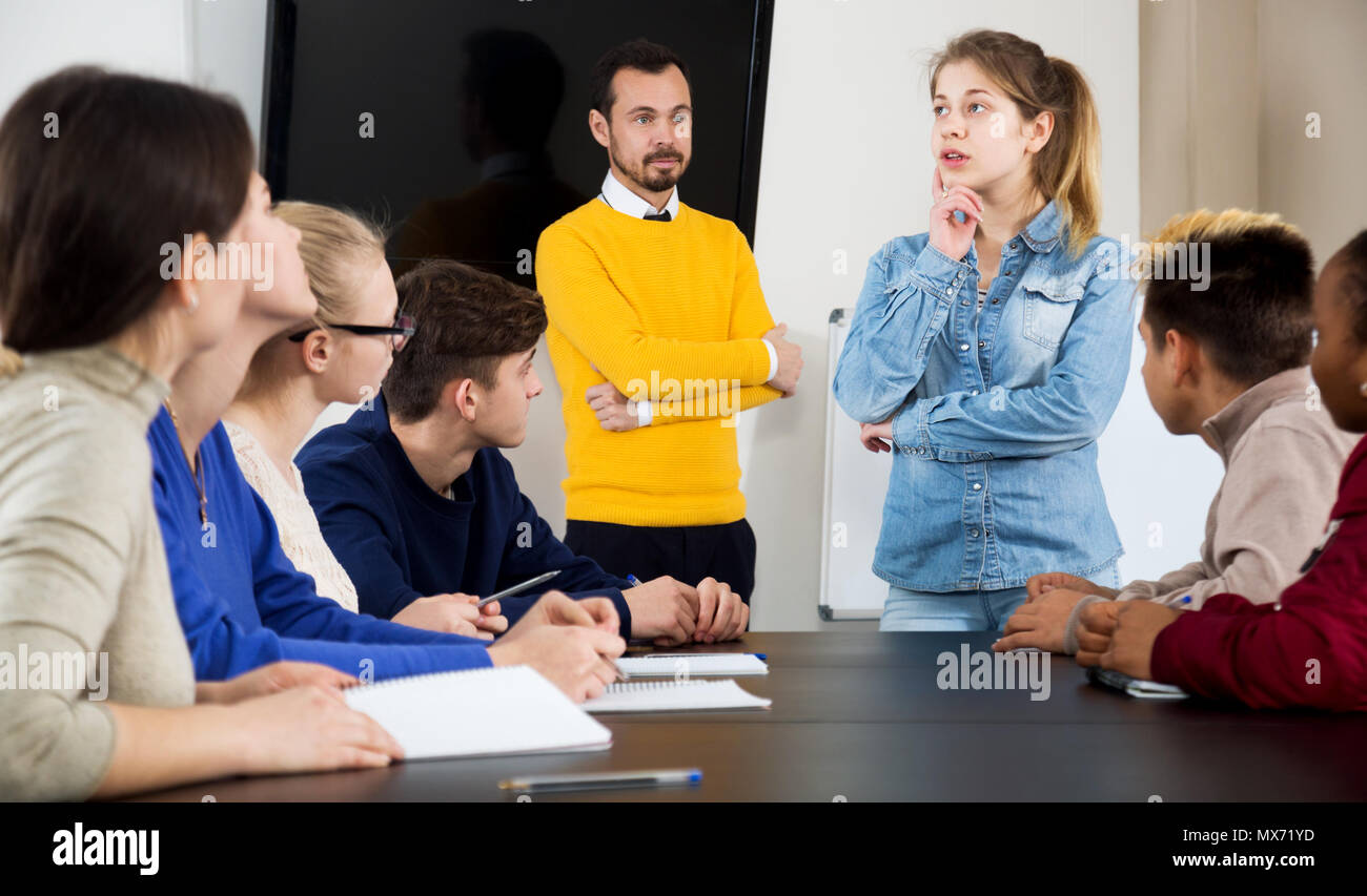 Glad girl in class ready giving good answer to teacher’s question at ...
