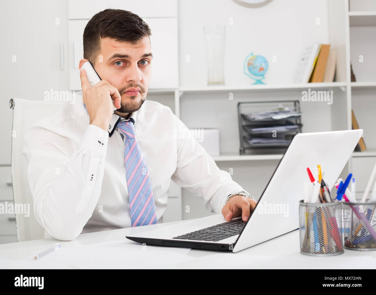 Male employee having productive day at work in office Stock Photo - Alamy