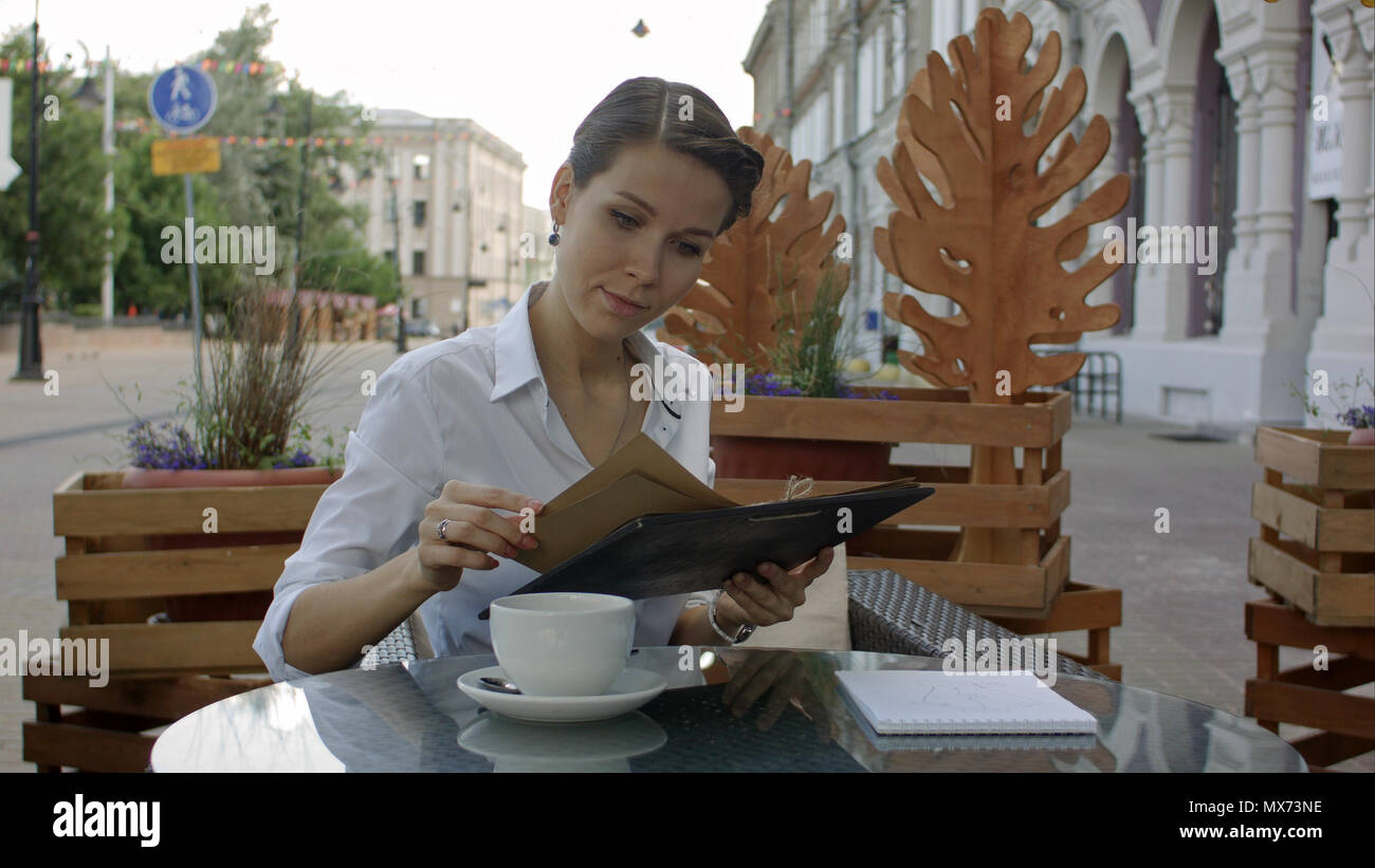 Women in cafe reading menu Stock Photo - Alamy