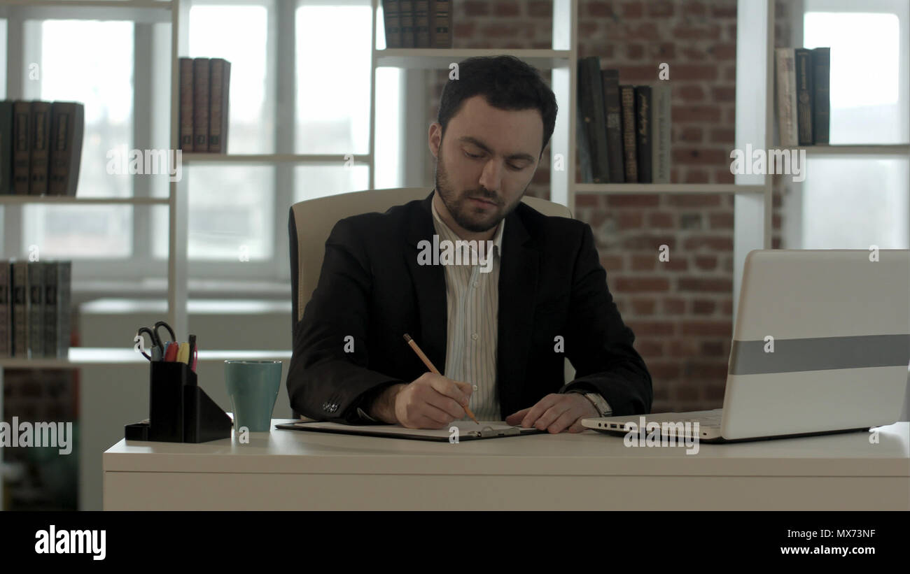 4k man writing in book hi-res stock photography and images - Alamy