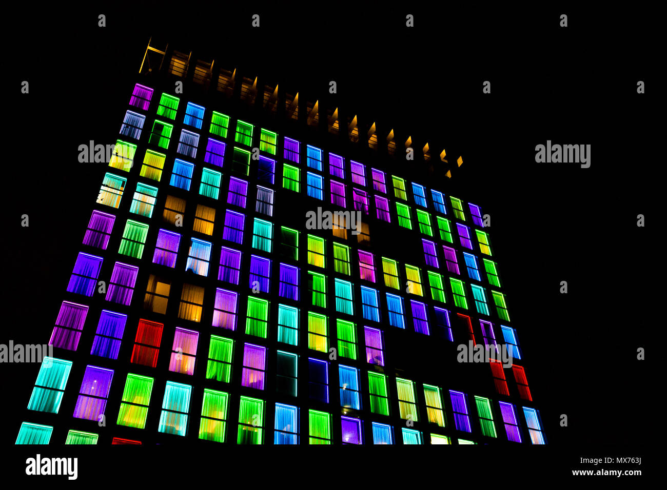 Colored windows texture. Windows illuminated by neon lights background ...