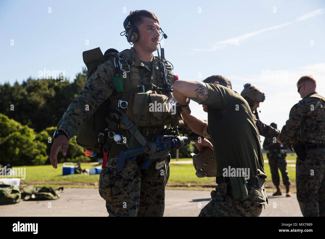 A Marine gets his parachute inspected to ensure he is ready to jump at ...
