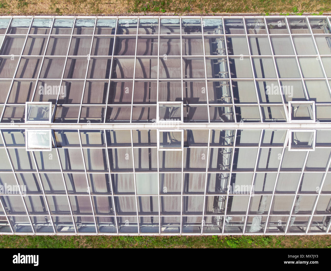 glass greenhouse rooftops with open windows. aerial view Stock Photo ...