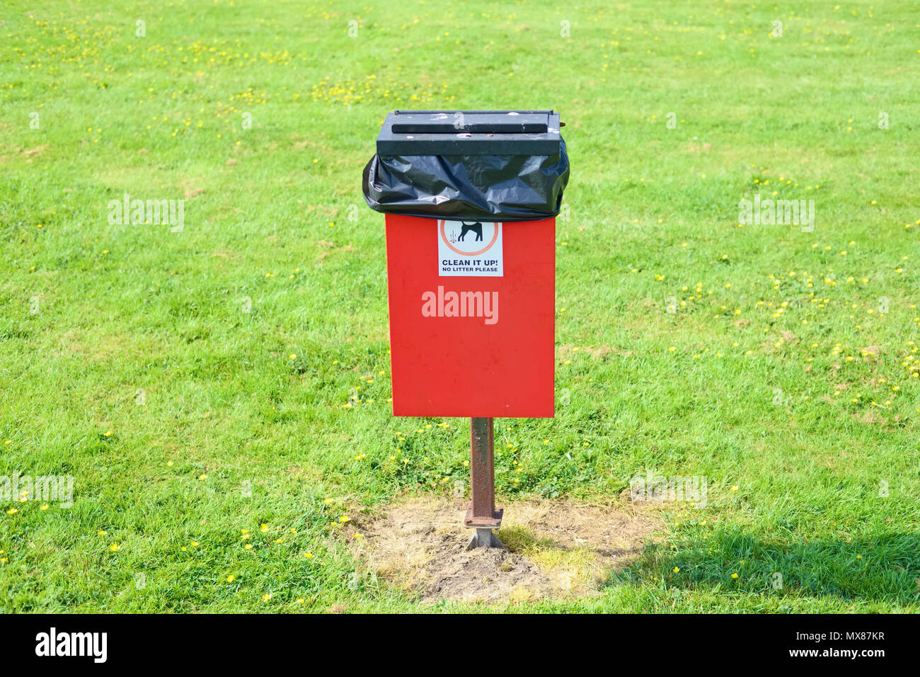 Dog poo waste bin bag environment sign on red bin in public park ...