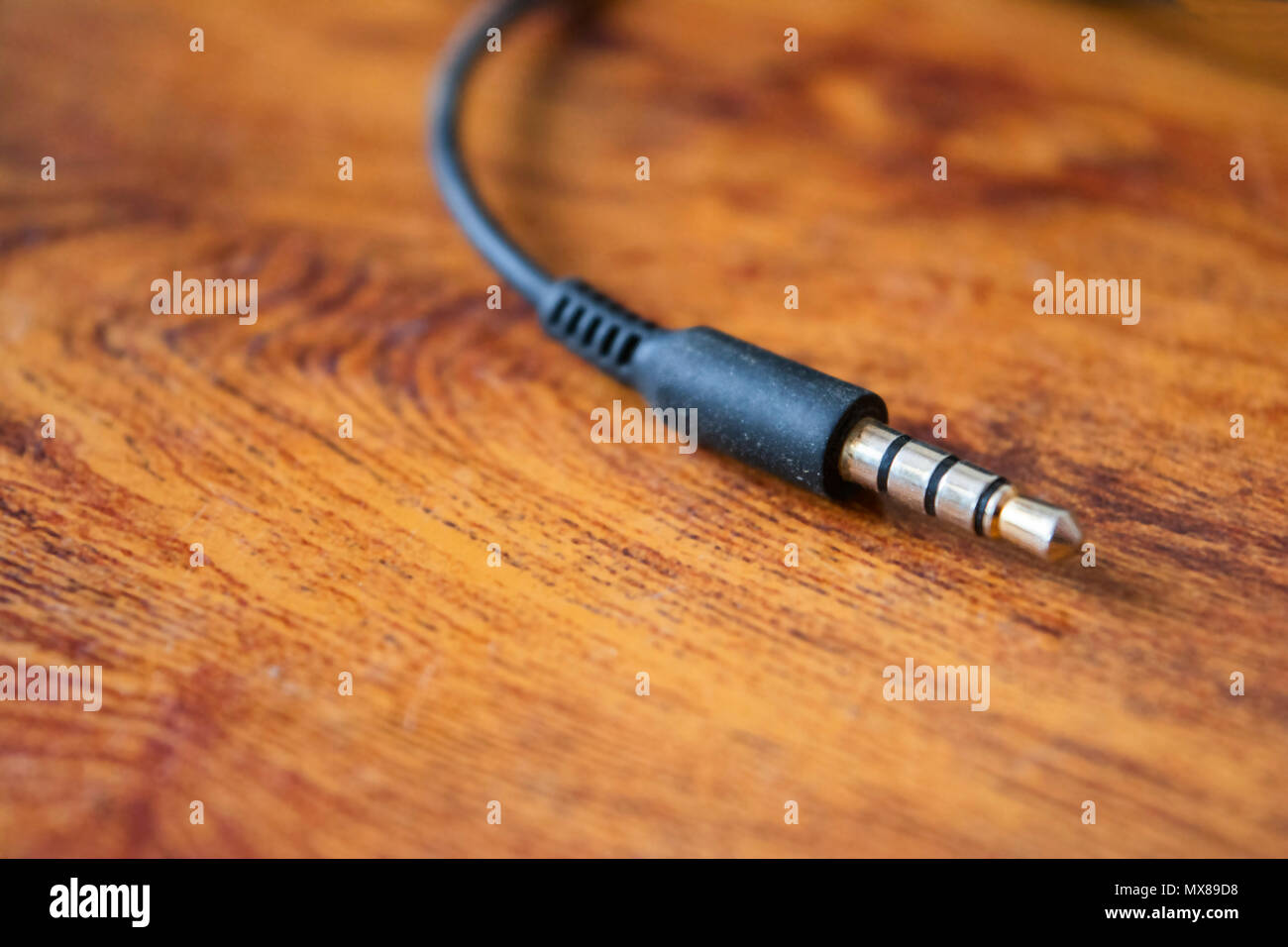 Earphone jack on abstract wooden background Stock Photo - Alamy