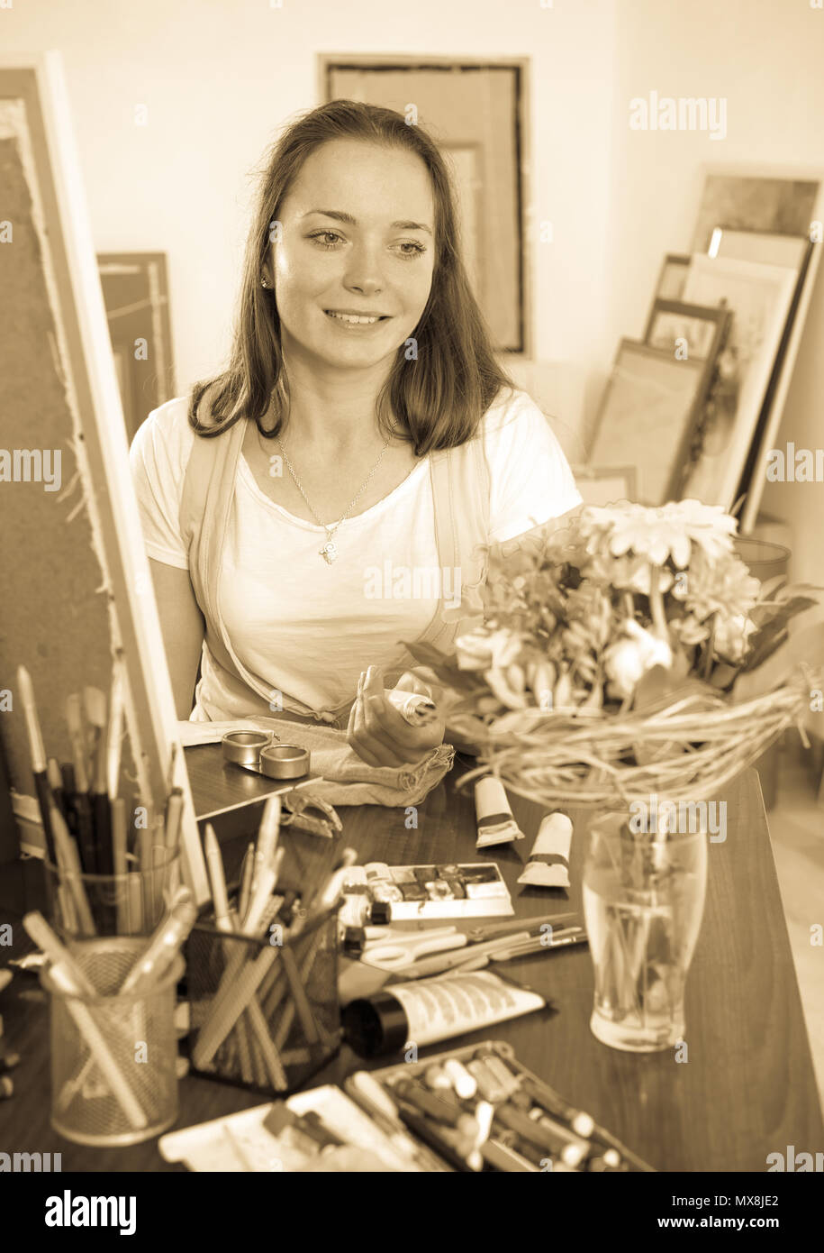 Cheerful young artist paints a picture at home Stock Photo - Alamy