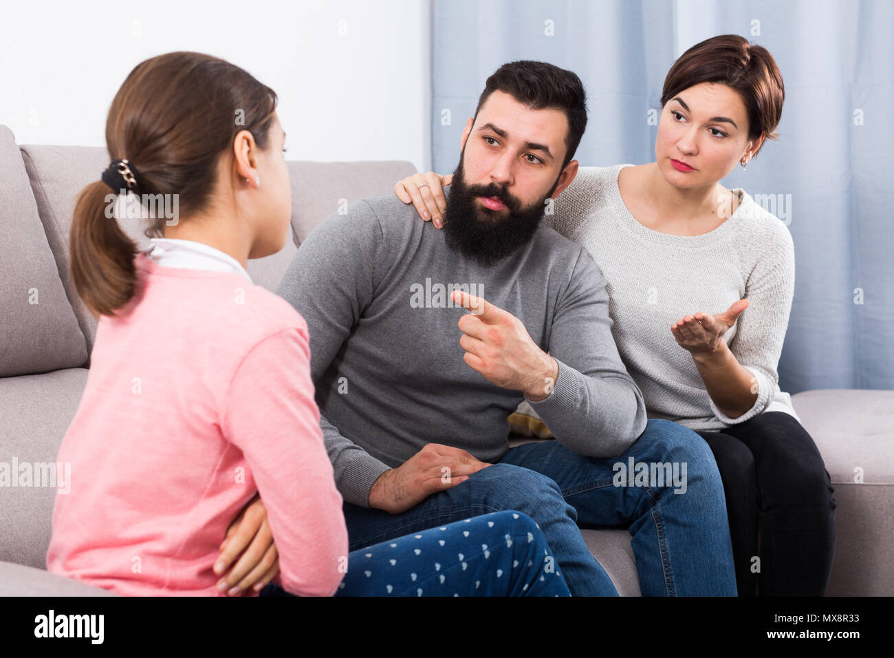 Young father and mother correcting their child for disobedience Stock ...