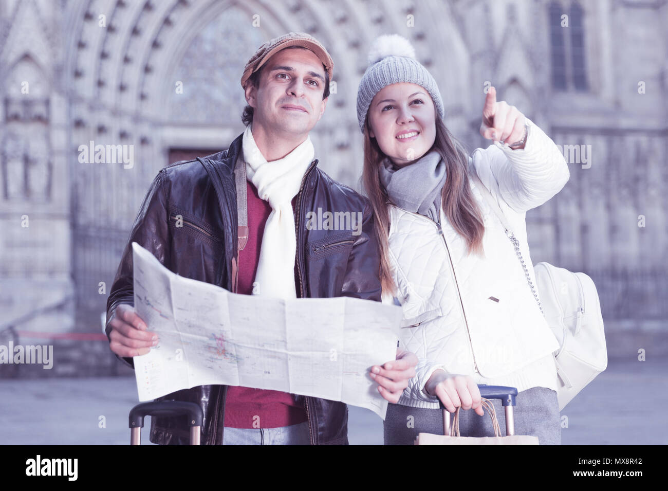 Portrait of adult tourists standing with map at street in hats Stock ...