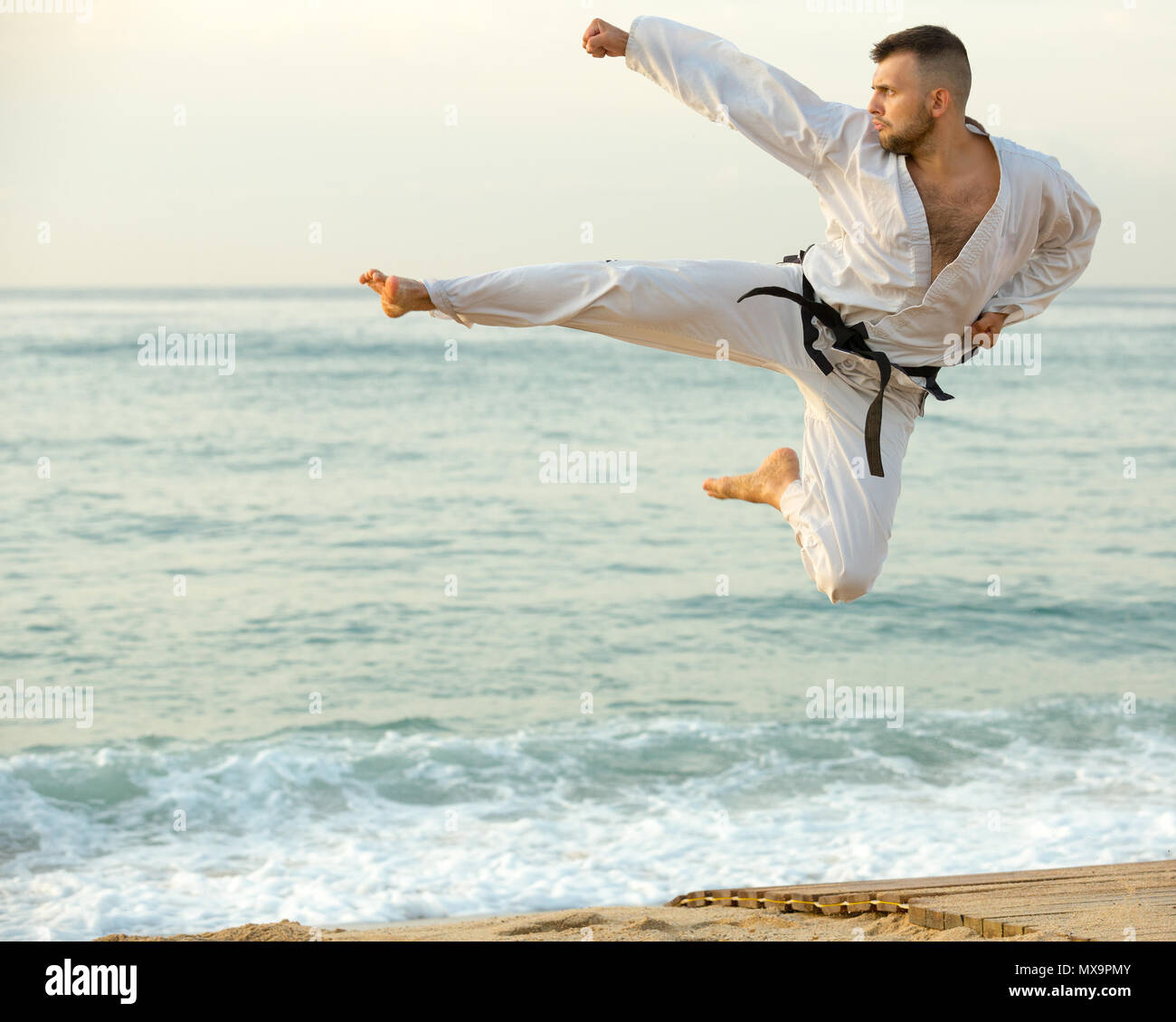 Laughing male practising karate kata poses at seaside Stock Photo - Alamy