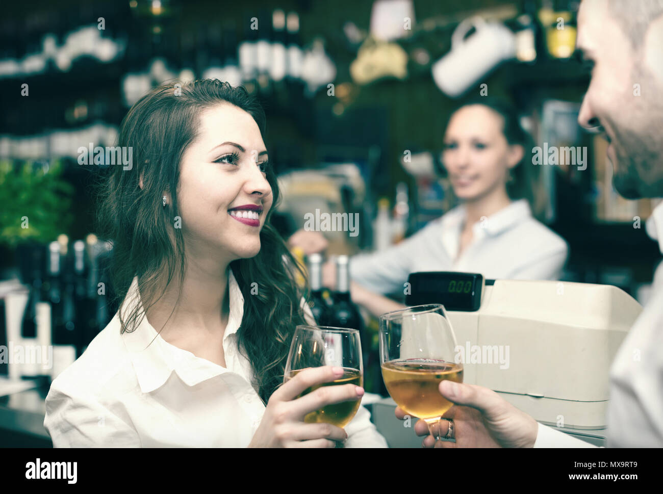 Small bar with young female barista and two clients at counter Stock ...