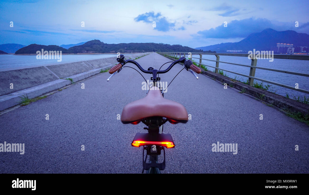 The rear of retro bicycle with brown leather seat and handle from ...