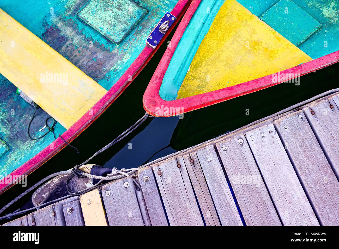 The colorful recreational boats and wooden pier from top view angle ...
