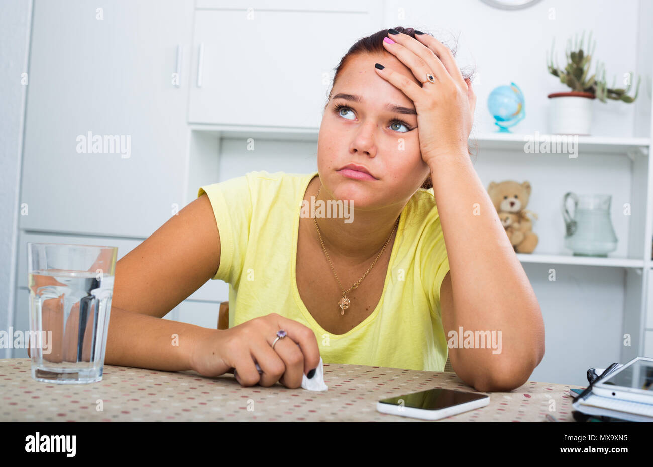 crying teenage girl looking at silent mobile phone indoors Stock Photo ...