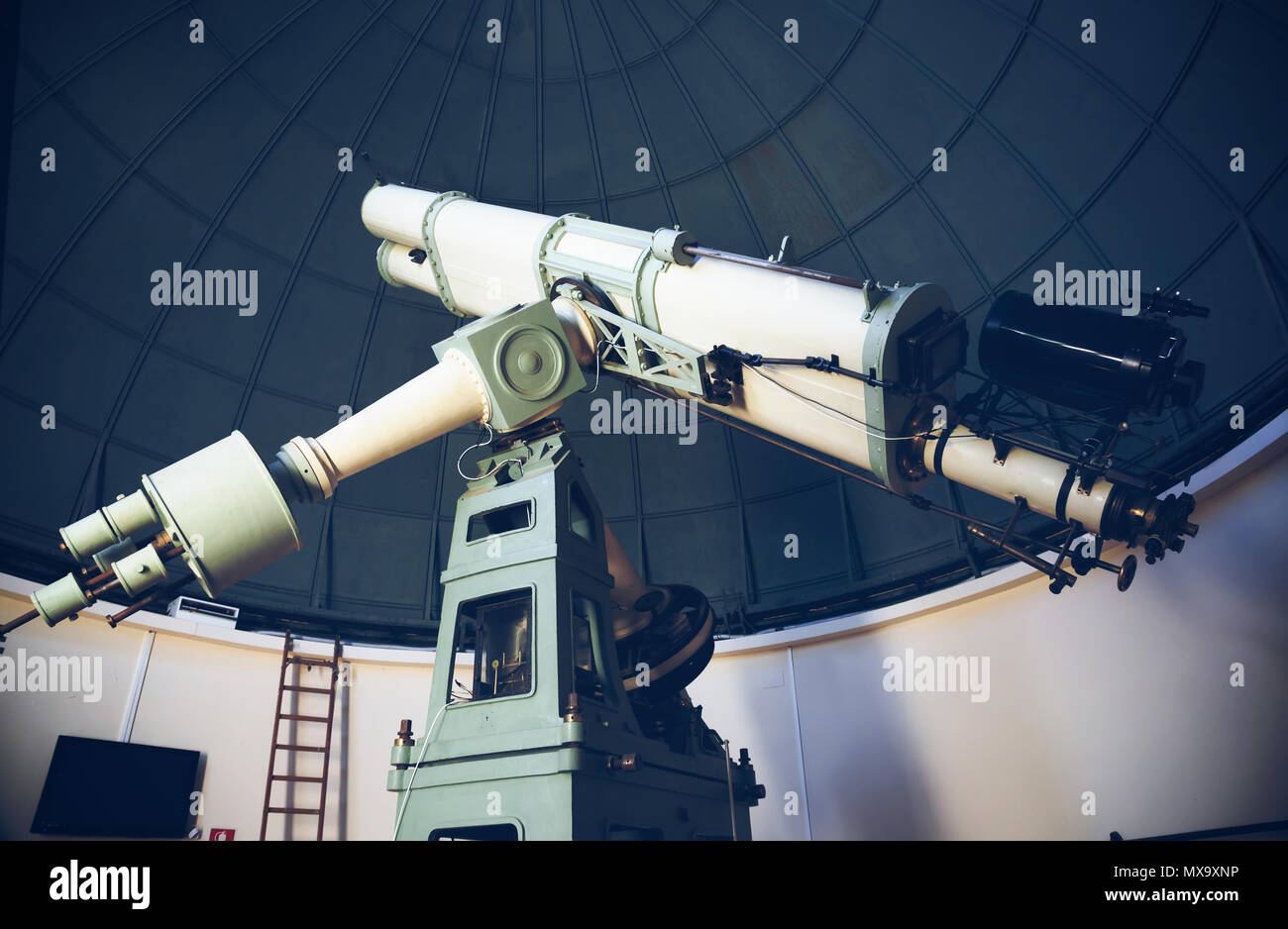 closeup view on oculars of large professional telescope located indoors ...