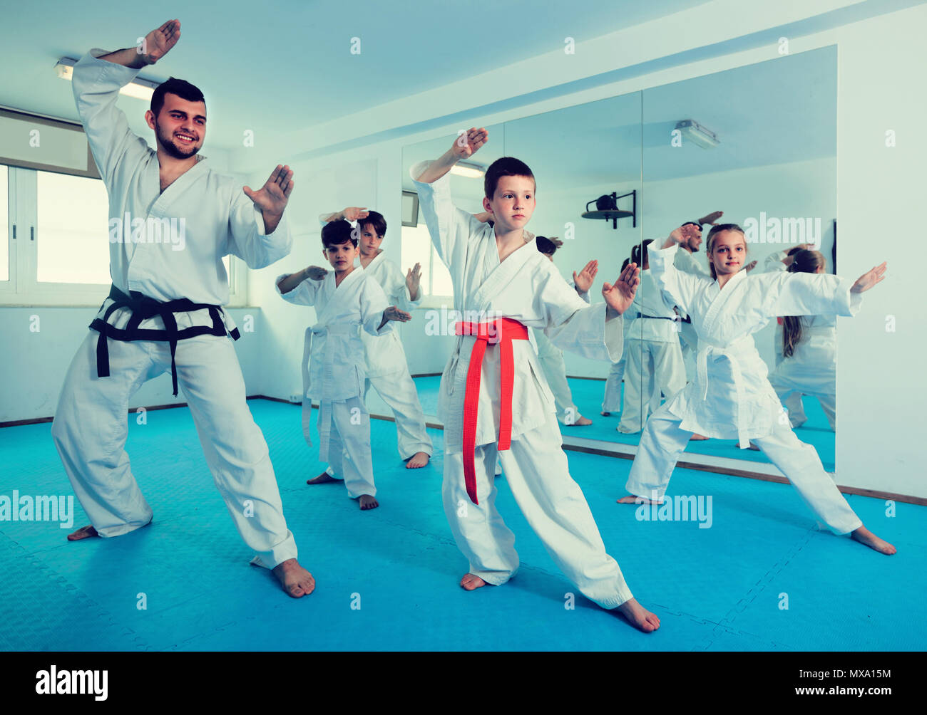 Coach is training children in karate class Stock Photo - Alamy