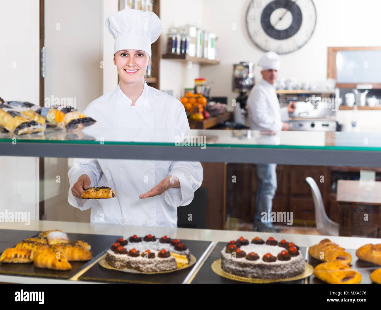 Bakery happy english female worker with delicious pies and rolls on ...