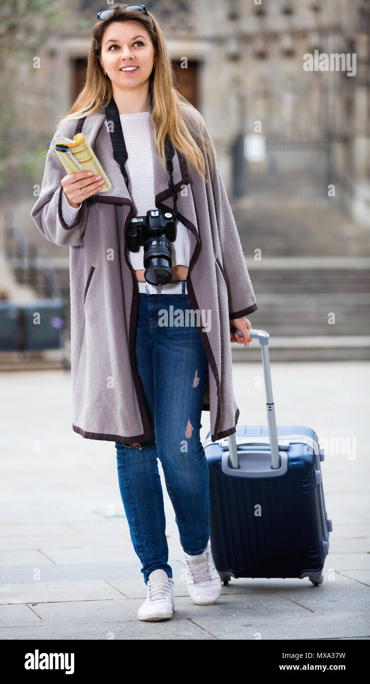Happy cheerful positive and inquisitive young girl taking a journey in the city Stock Photo - Alamy